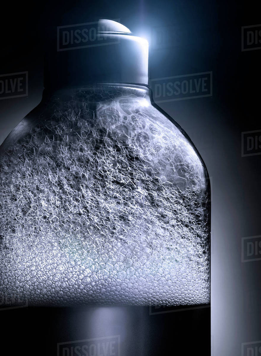 Transparent liquid and foam in glass bottle - Royalty-free Stock Photo ...