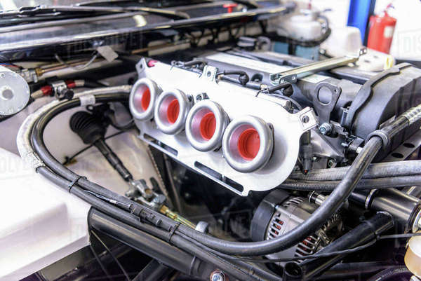 Engine detail in racing car factory - Stock Photo - Dissolve