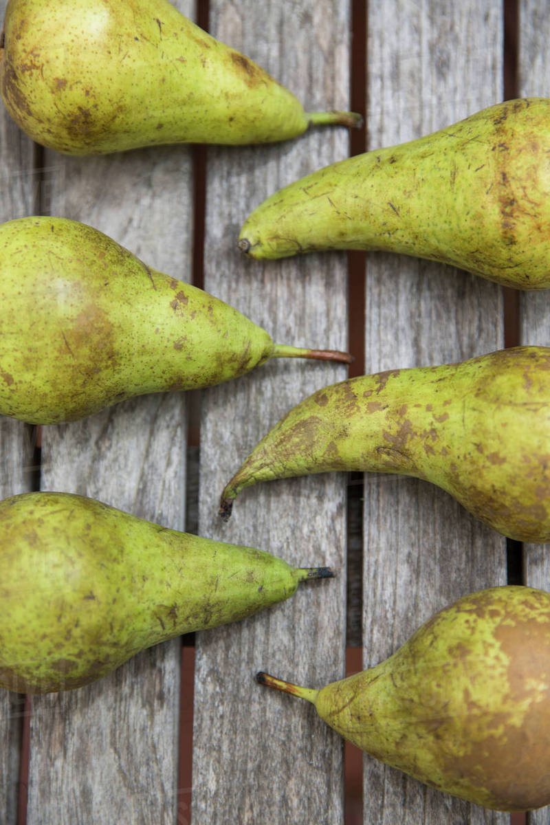 Overhead view of six pears on table - Stock Photo - Dissolve