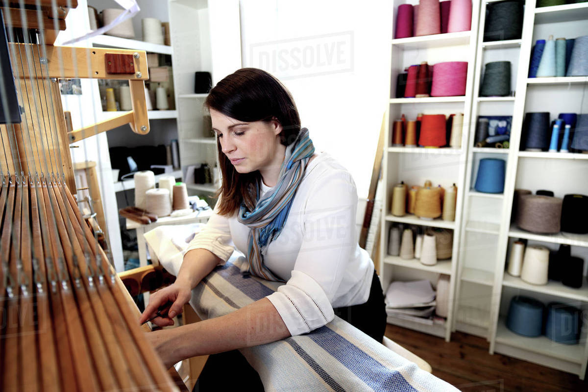 Young woman using loom - Royalty-free Stock Photo | Dissolve