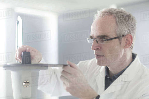 Male meteorologist preparing equipment in weather station laboratory ...