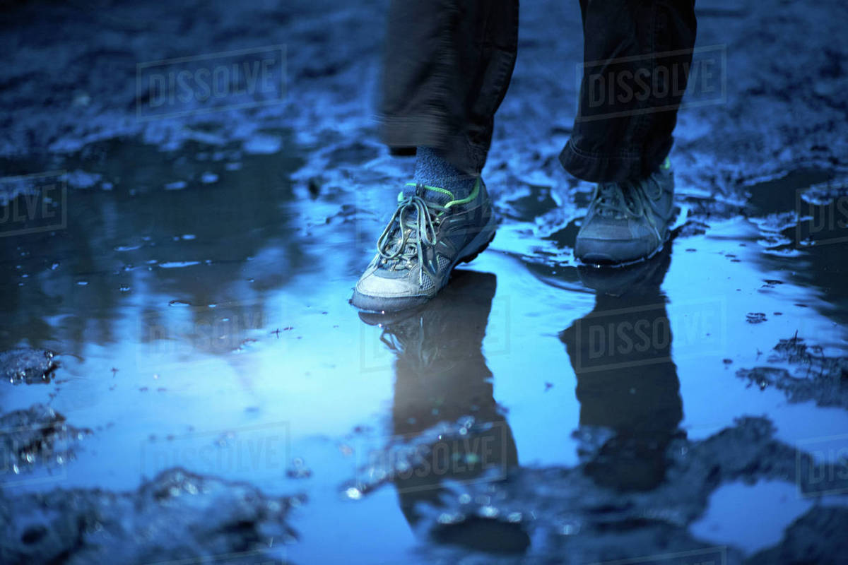 Feet of female hiker stepping in muddy puddle - Royalty-free Stock ...
