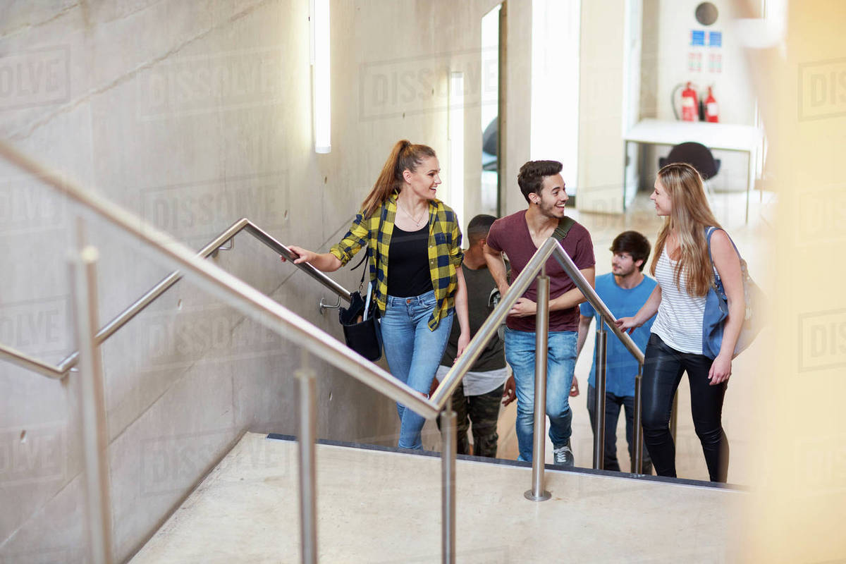 Group of students moving up stairway at higher education college ...