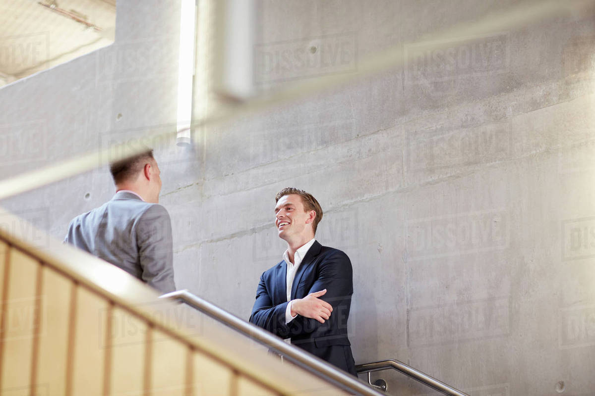 Two businessmen talking on office stairway - Royalty-free Stock Photo ...