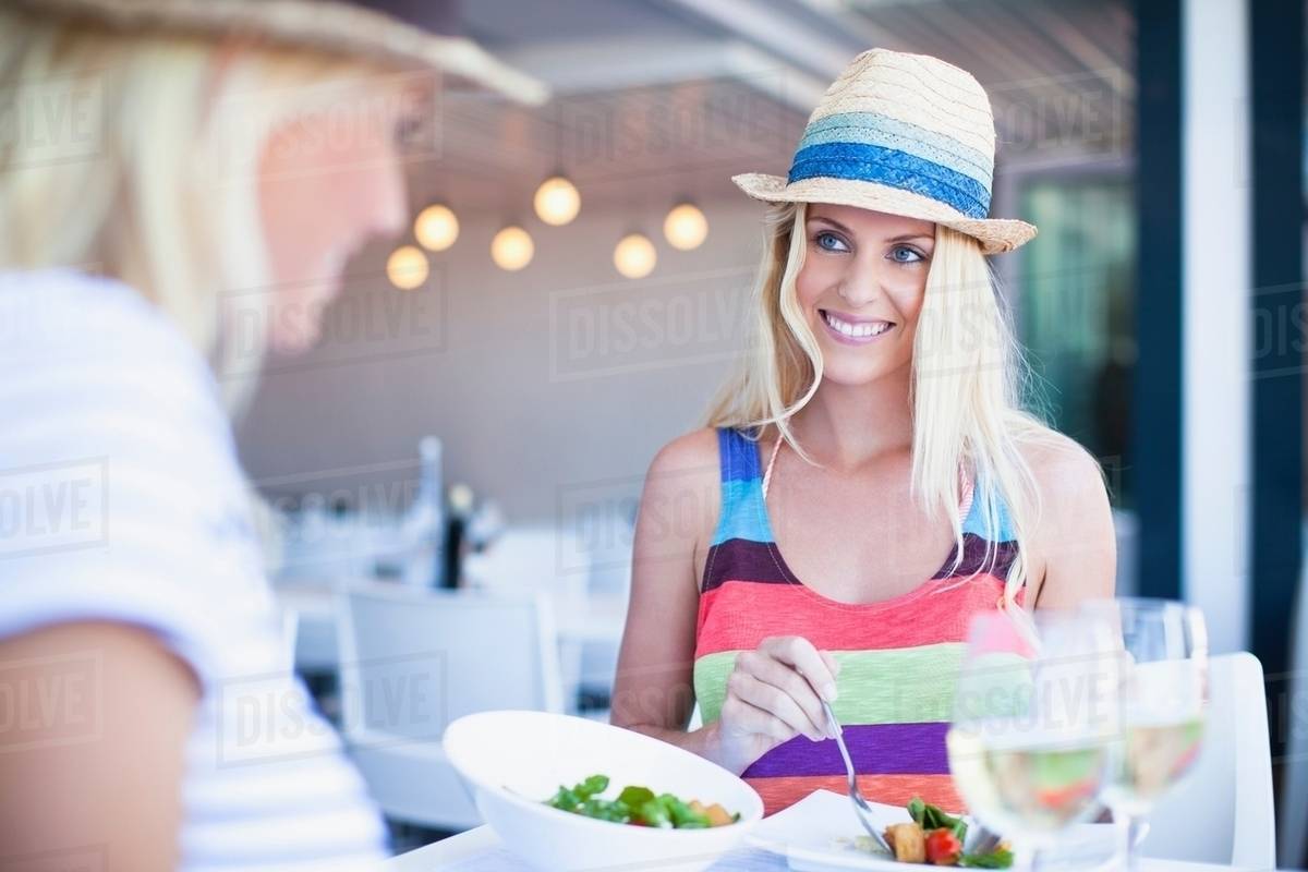 Women eating together in cafe - Royalty-free Stock Photo | Dissolve