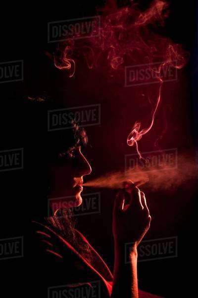Illuminated profile of woman smoking - Royalty-free Stock Photo | Dissolve