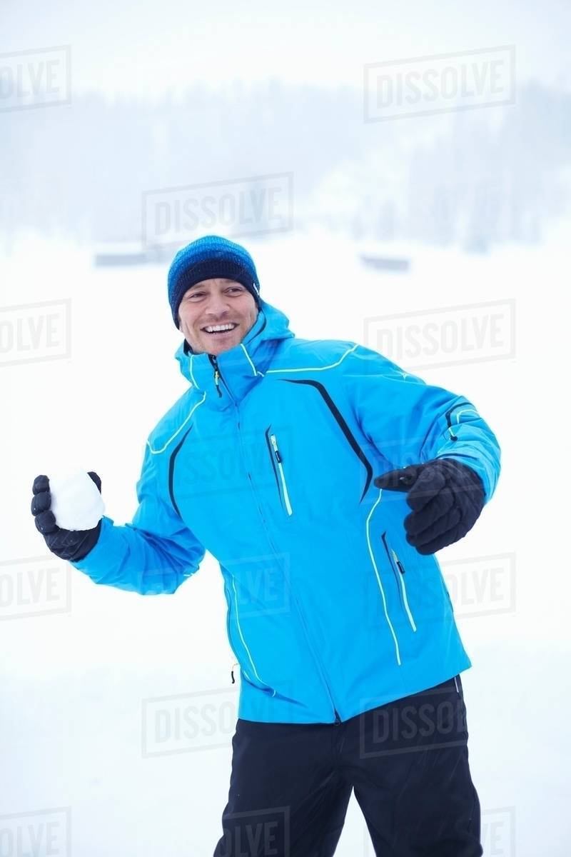 Man throwing snowball outdoors - Royalty-free Stock Photo | Dissolve