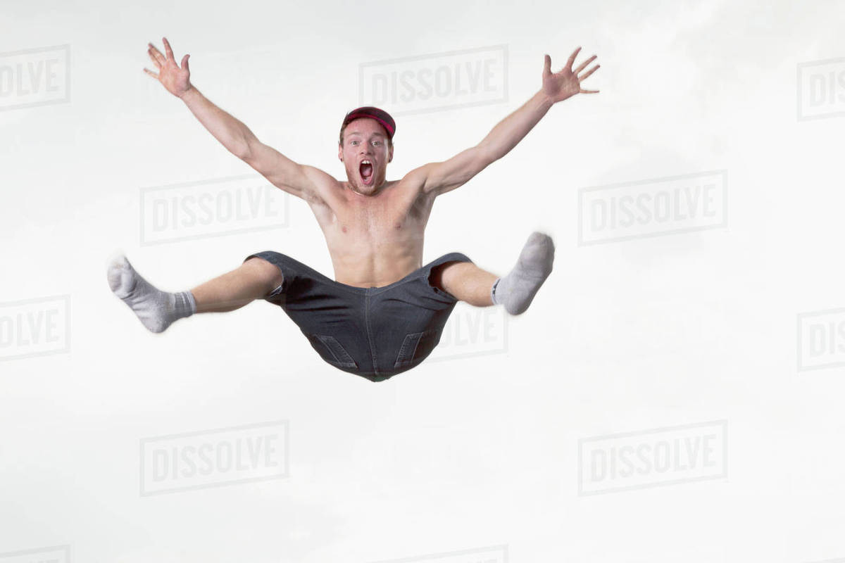 Bare chested man jumping in mid air - Royalty-free Stock Photo | Dissolve