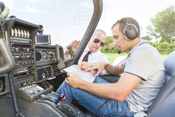 Pilot and co-pilot talking through flight plan - Stock Photo - Dissolve