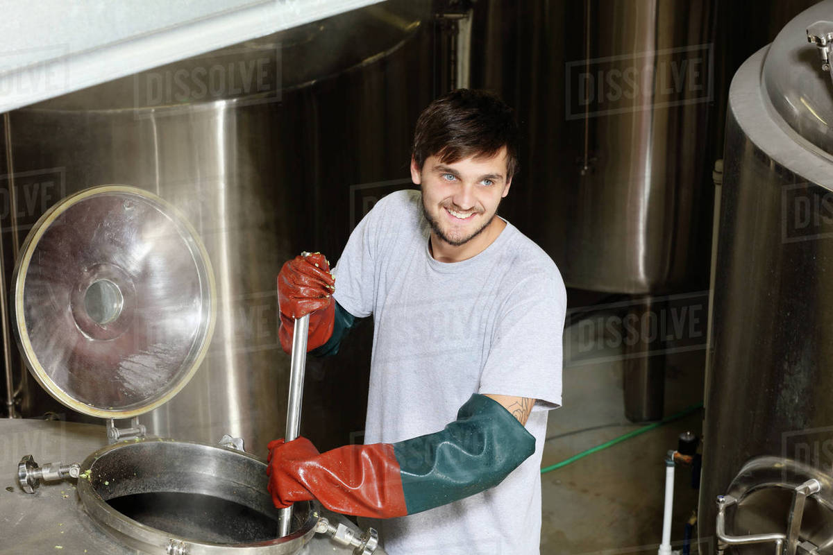 Worker in brewery, adding hops to brew kettle - Royalty-free Stock ...