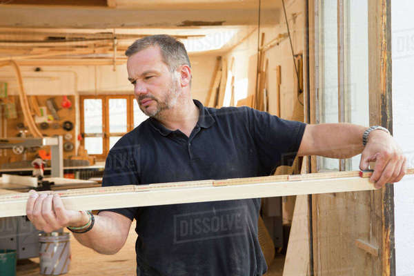 Man quality checking timber - Royalty-free Stock Photo | Dissolve
