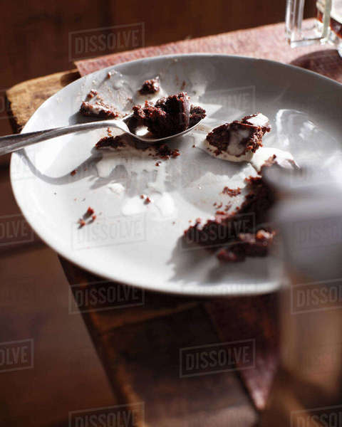 Leftover chocolate pudding on plate - Royalty-free Stock Photo | Dissolve