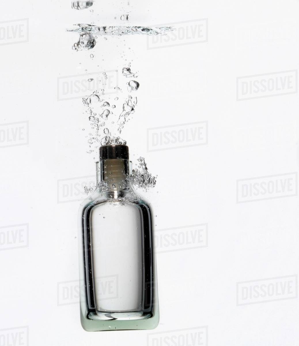 Bottle splashing in water - Royalty-free Stock Photo | Dissolve