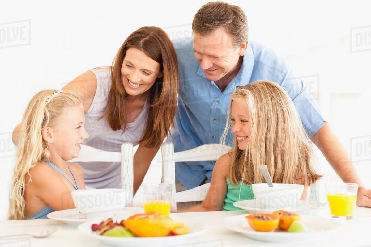 Family talking at breakfast table - Stock Photo - Dissolve