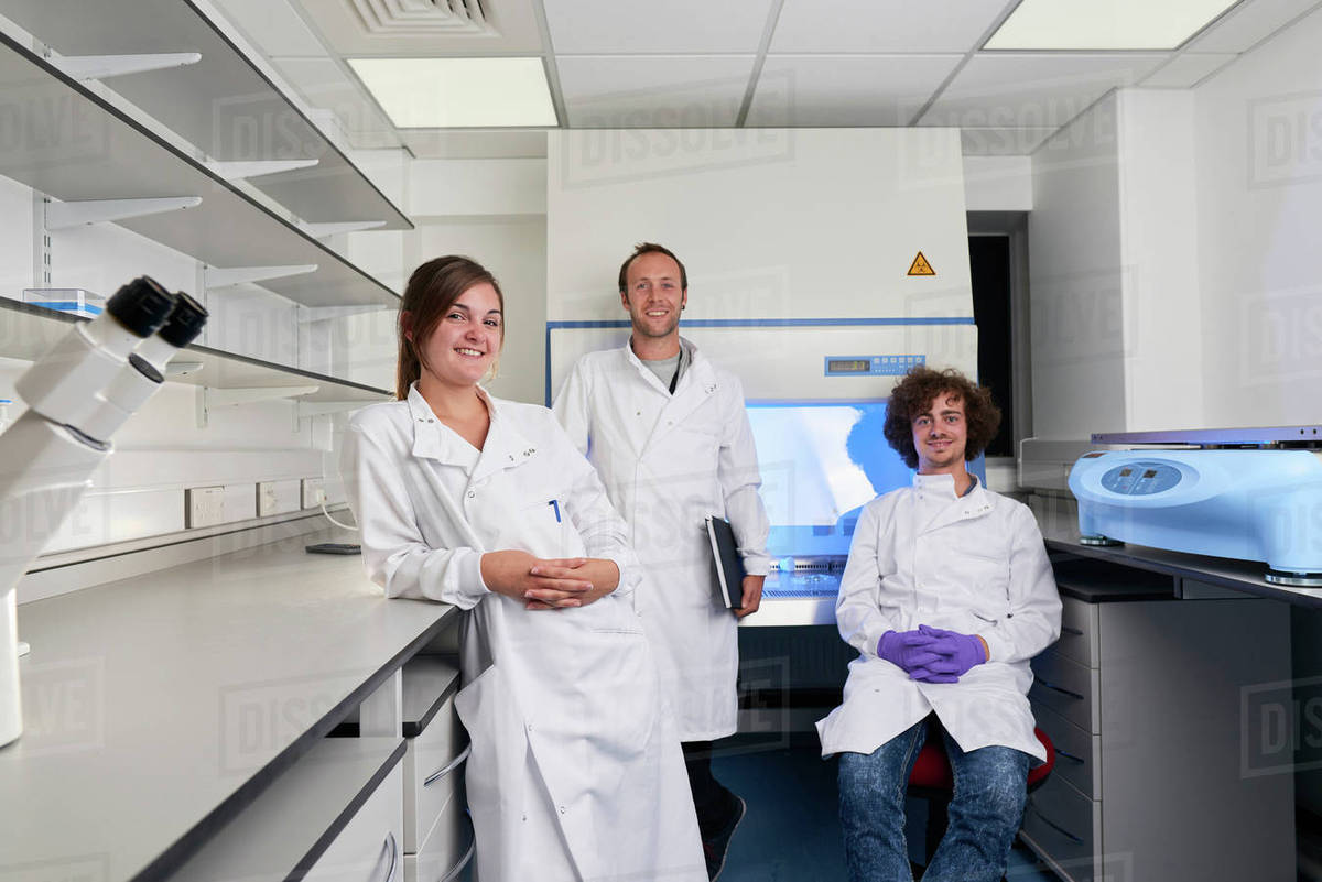 Scientists in laboratory looking at camera smiling - Royalty-free Stock ...