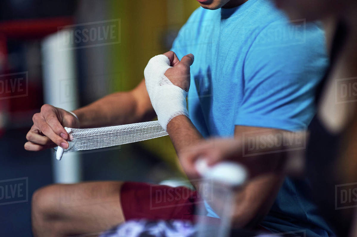 Cropped shot of young male and female boxers bandaging hands - Stock ...