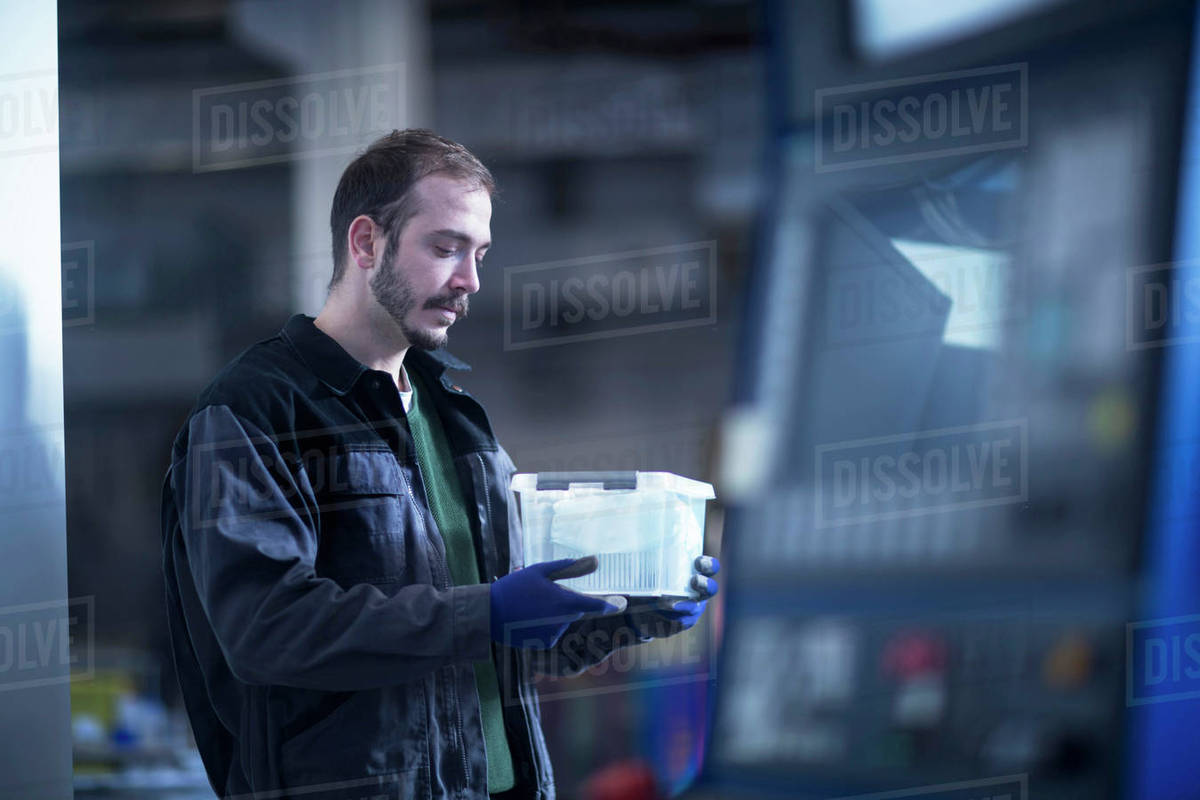 Engineer carrying plastic storage box - Royalty-free Stock Photo | Dissolve