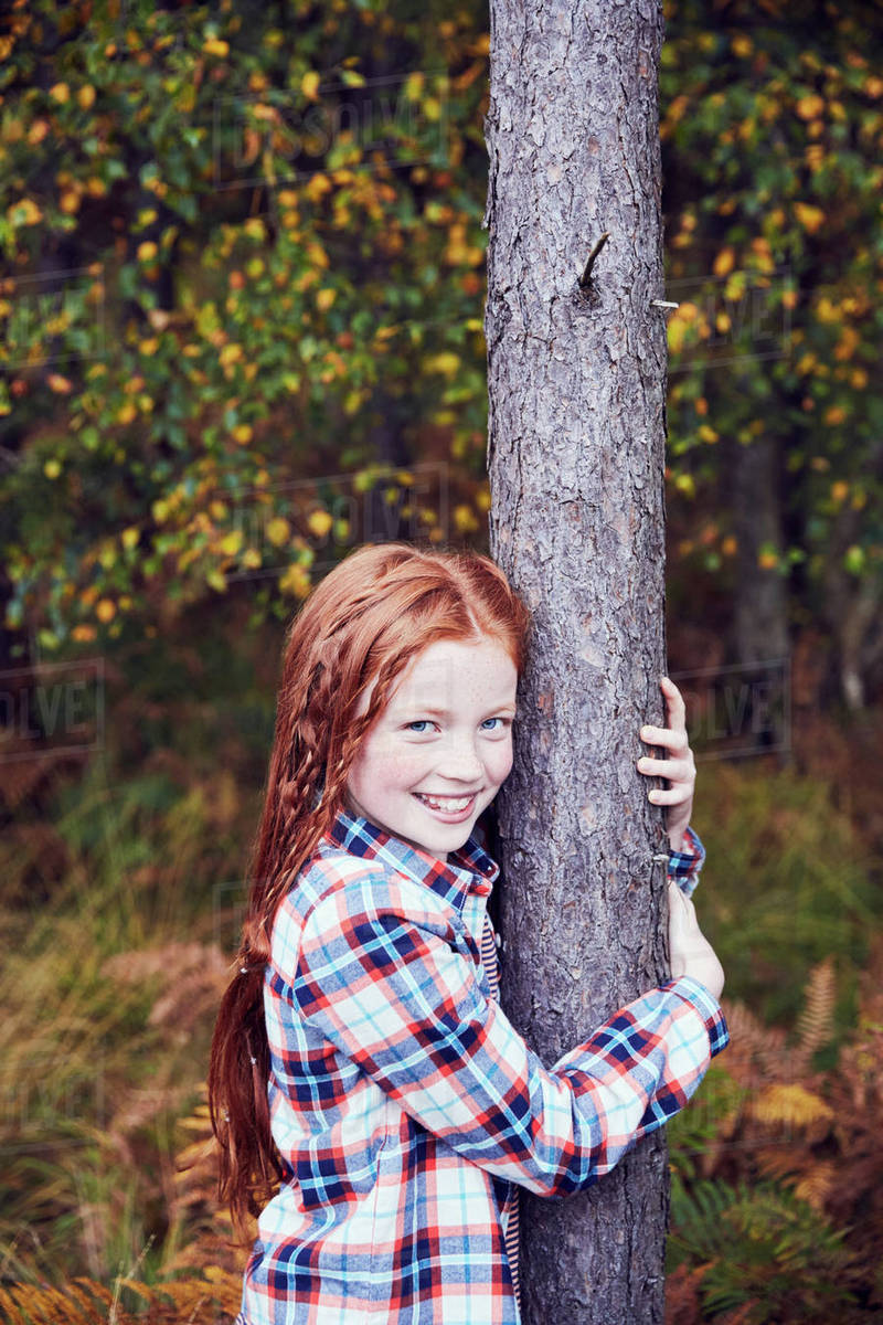 Portrait of young girl, hugging tree, smiling - Royalty-free Stock ...