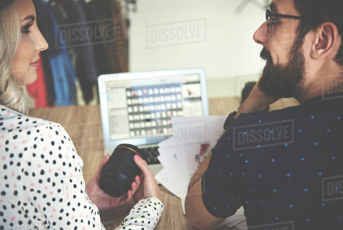 Photographer and stylist having discussion in photography studio ...
