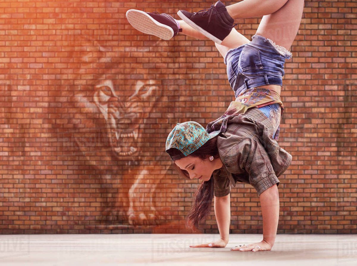 Dancer doing back flip, tiger street art in background - Stock Photo ...
