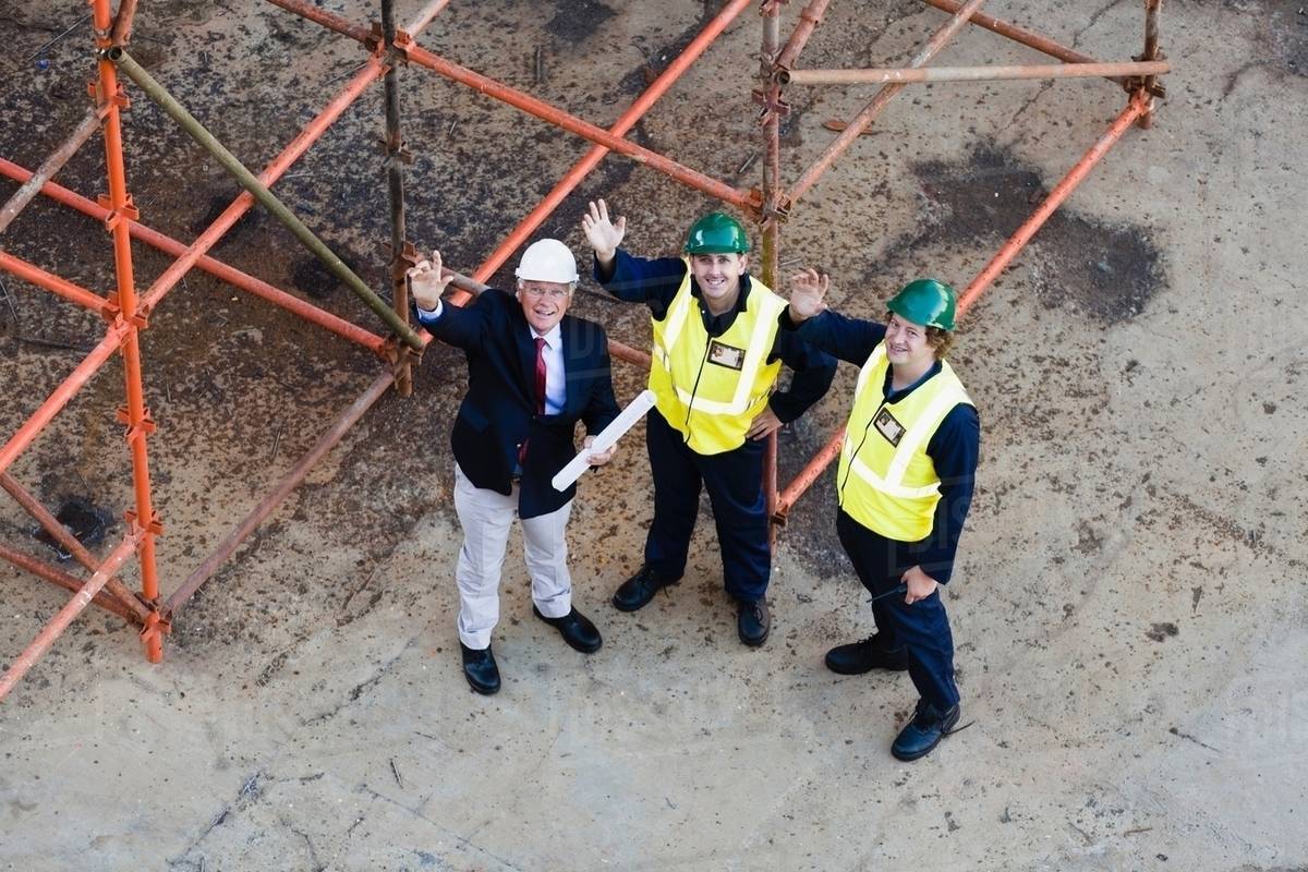 Workers waving from dry dock - Stock Photo - Dissolve