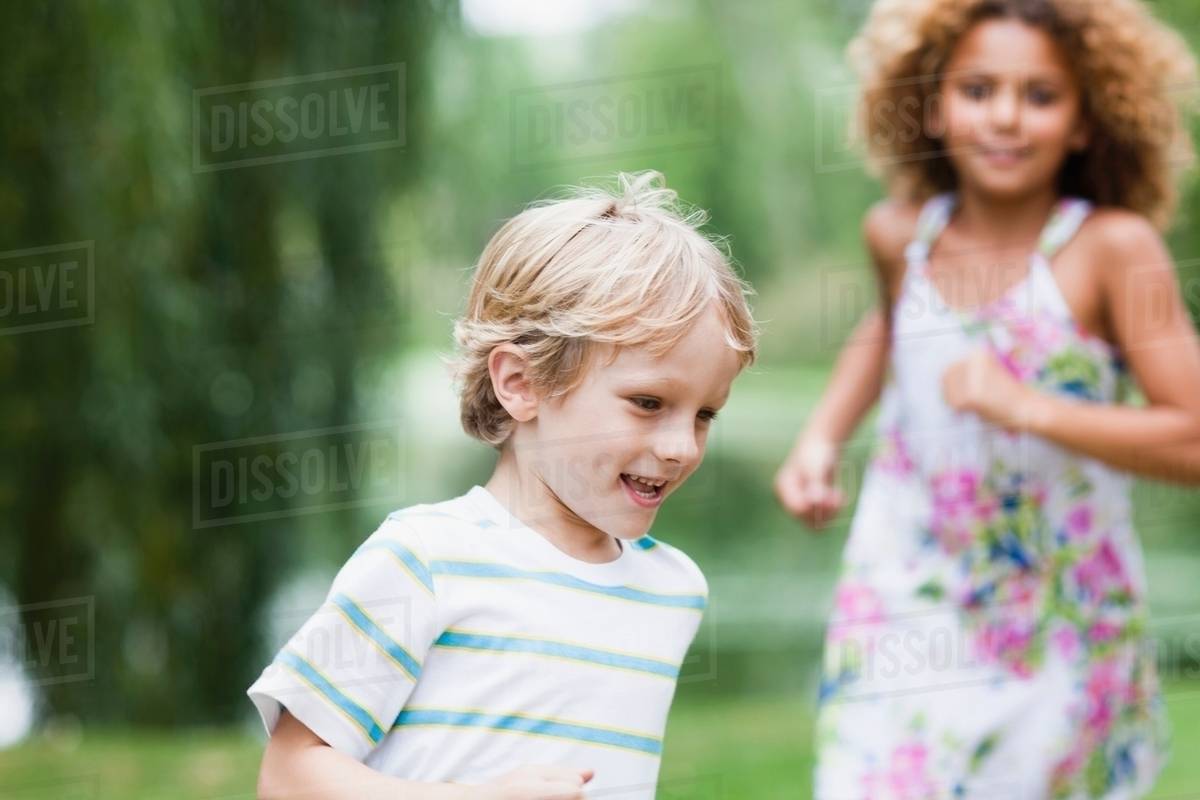 Children playing together outdoors - Stock Photo - Dissolve