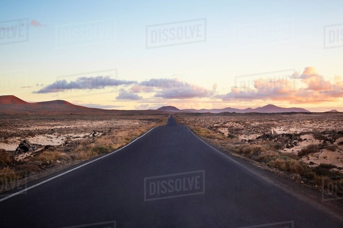 Paved road in rural landscape - Royalty-free Stock Photo | Dissolve