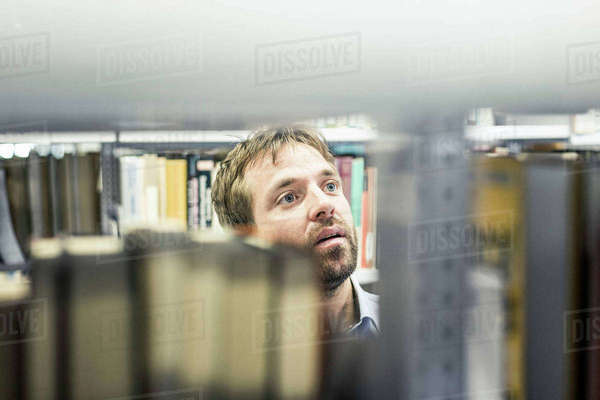 Businessman looking at file shelves in office storeroom - Stock Photo ...
