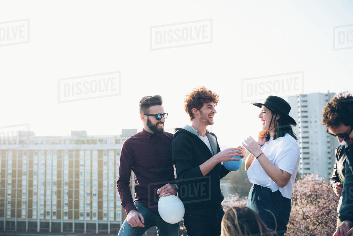 Group of friends enjoying roof party - Stock Photo - Dissolve