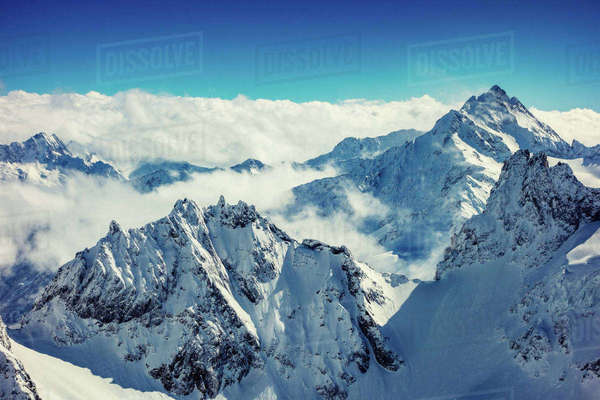 Clouds on snow capped mountain peaks, Engelberg Titlis, Swiss Alps ...