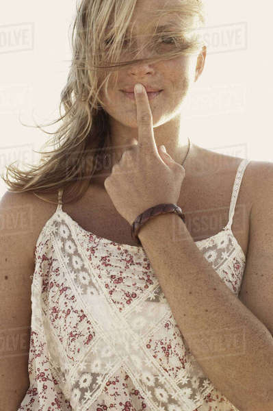 Woman with one finger over her lips - Royalty-free Stock Photo | Dissolve