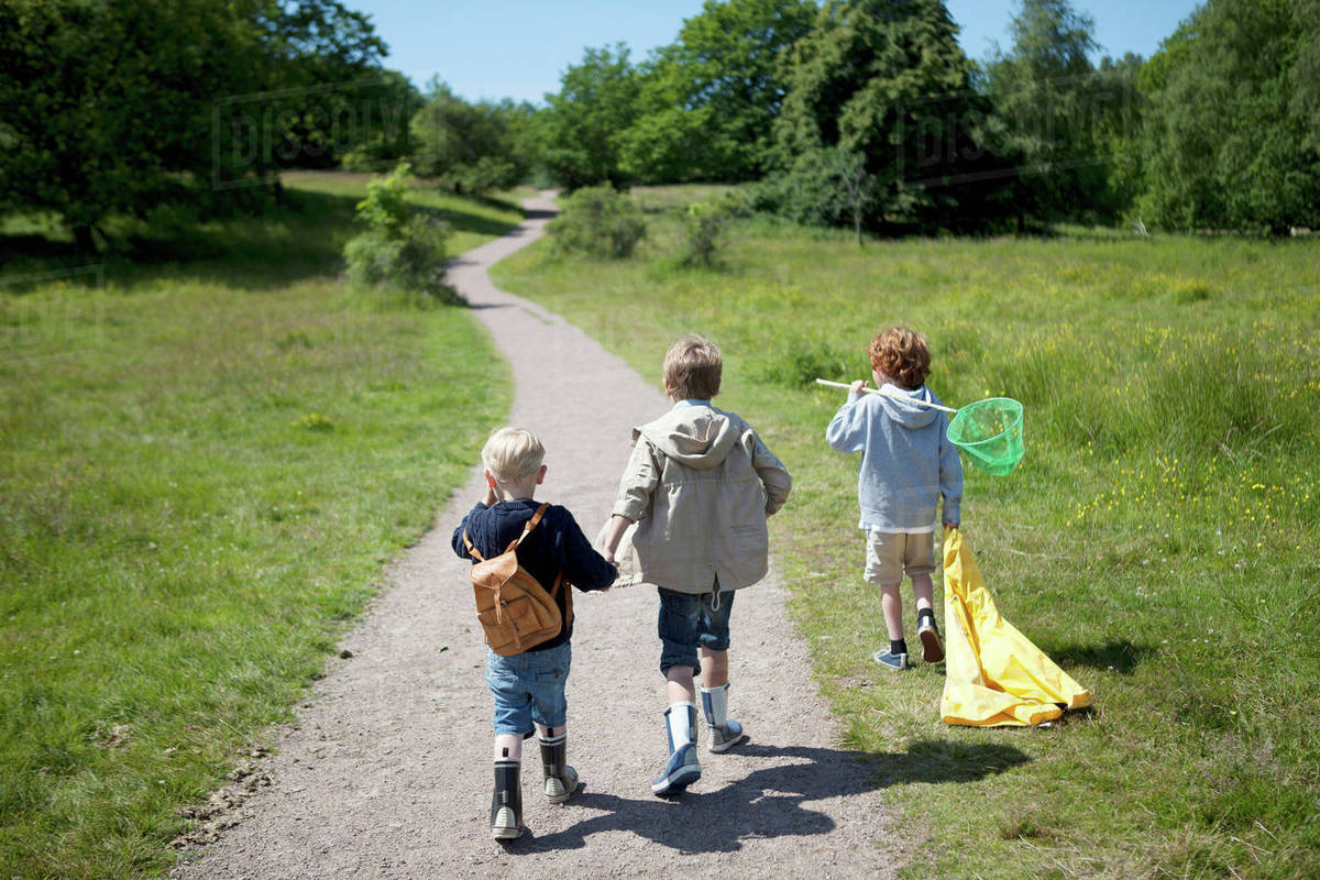 Children walking on dirt road - Royalty-free Stock Photo | Dissolve