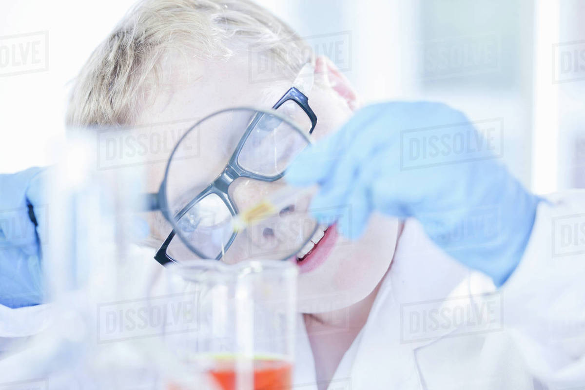 Boy playing scientist in lab - Royalty-free Stock Photo | Dissolve