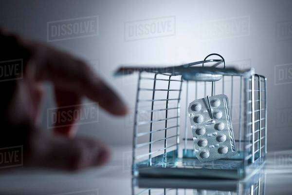 Blister pack of pills in cage trap - Royalty-free Stock Photo | Dissolve