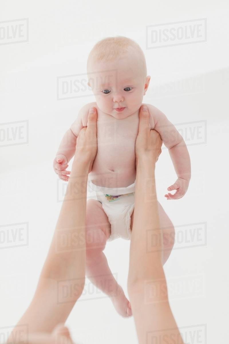 Mother lifting baby in air - Royalty-free Stock Photo | Dissolve