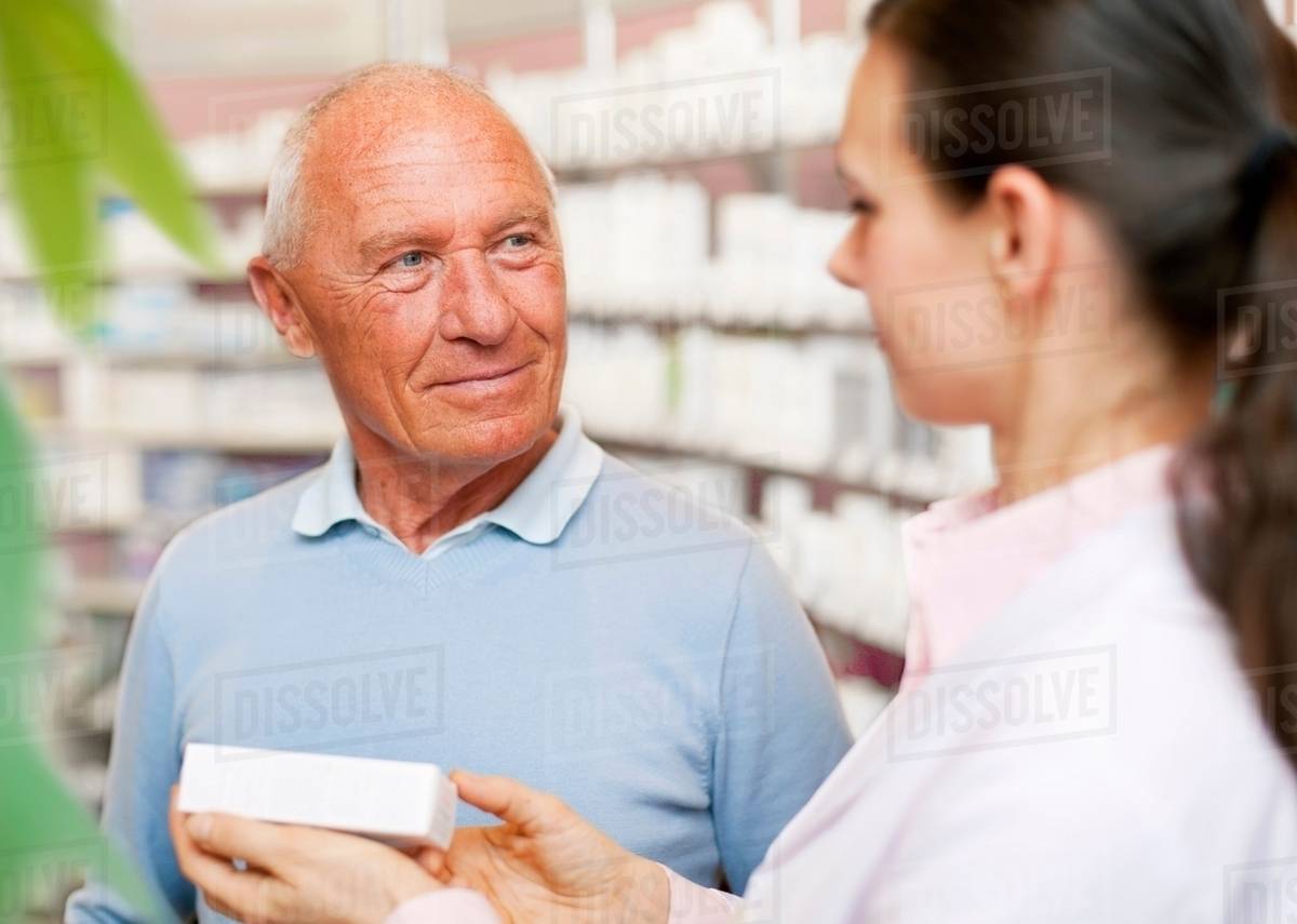 Pharmacist talking to patient in store - Royalty-free Stock Photo ...