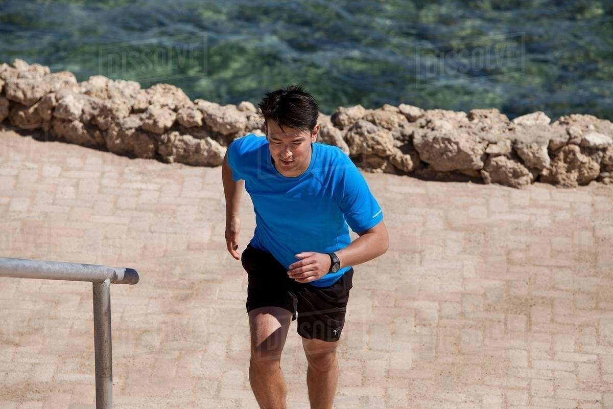 Man running up steps outdoors - Royalty-free Stock Photo | Dissolve