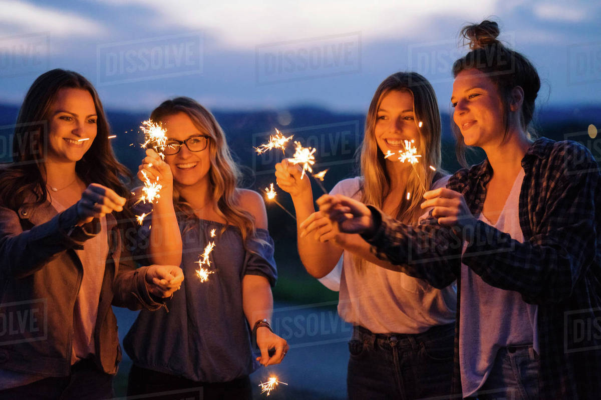 Friends playing with sparklers - Royalty-free Stock Photo | Dissolve