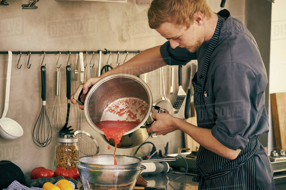 Chef cooking in commercial kitchen - Royalty-free Stock Photo | Dissolve