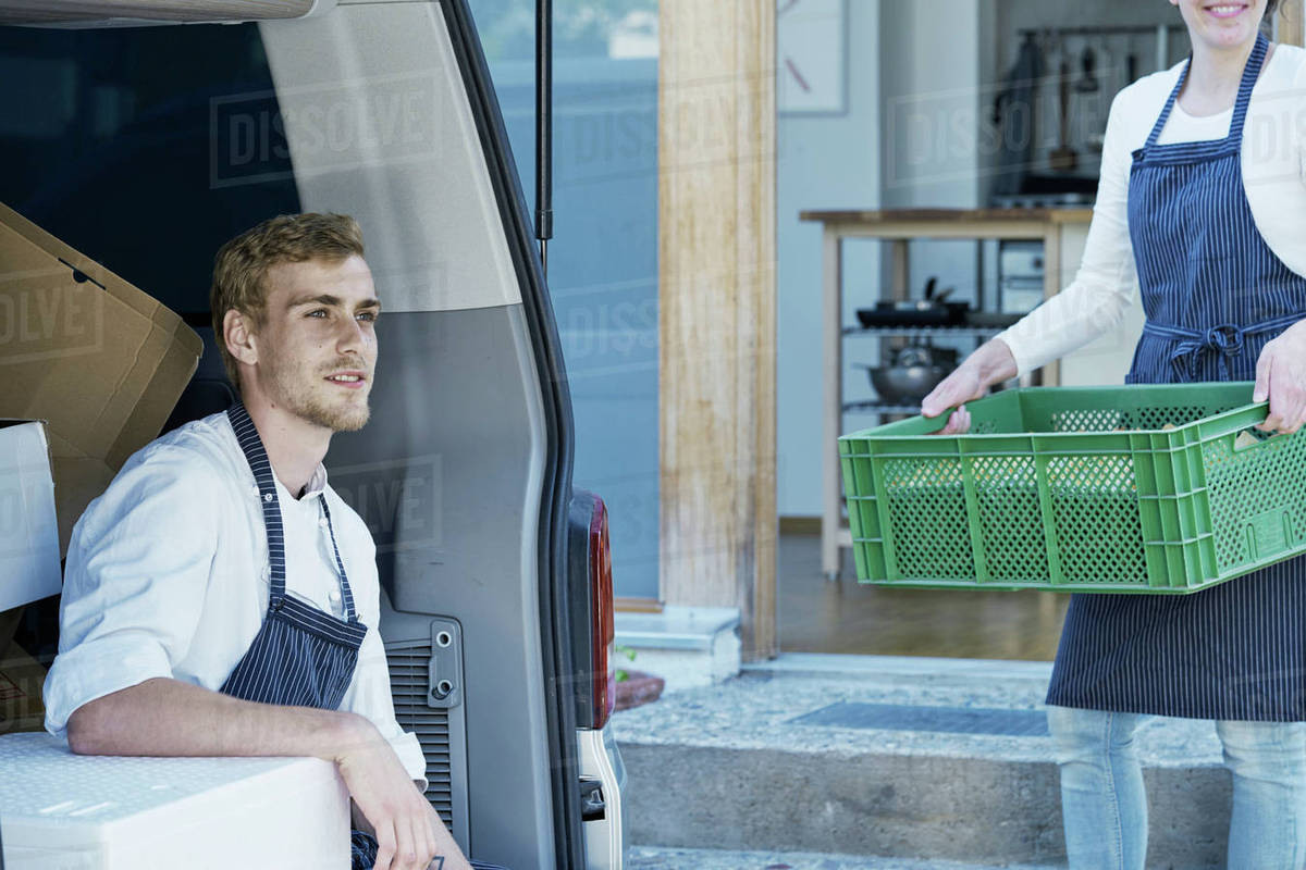 Caterers loading vehicle with prepared food - Stock Photo - Dissolve