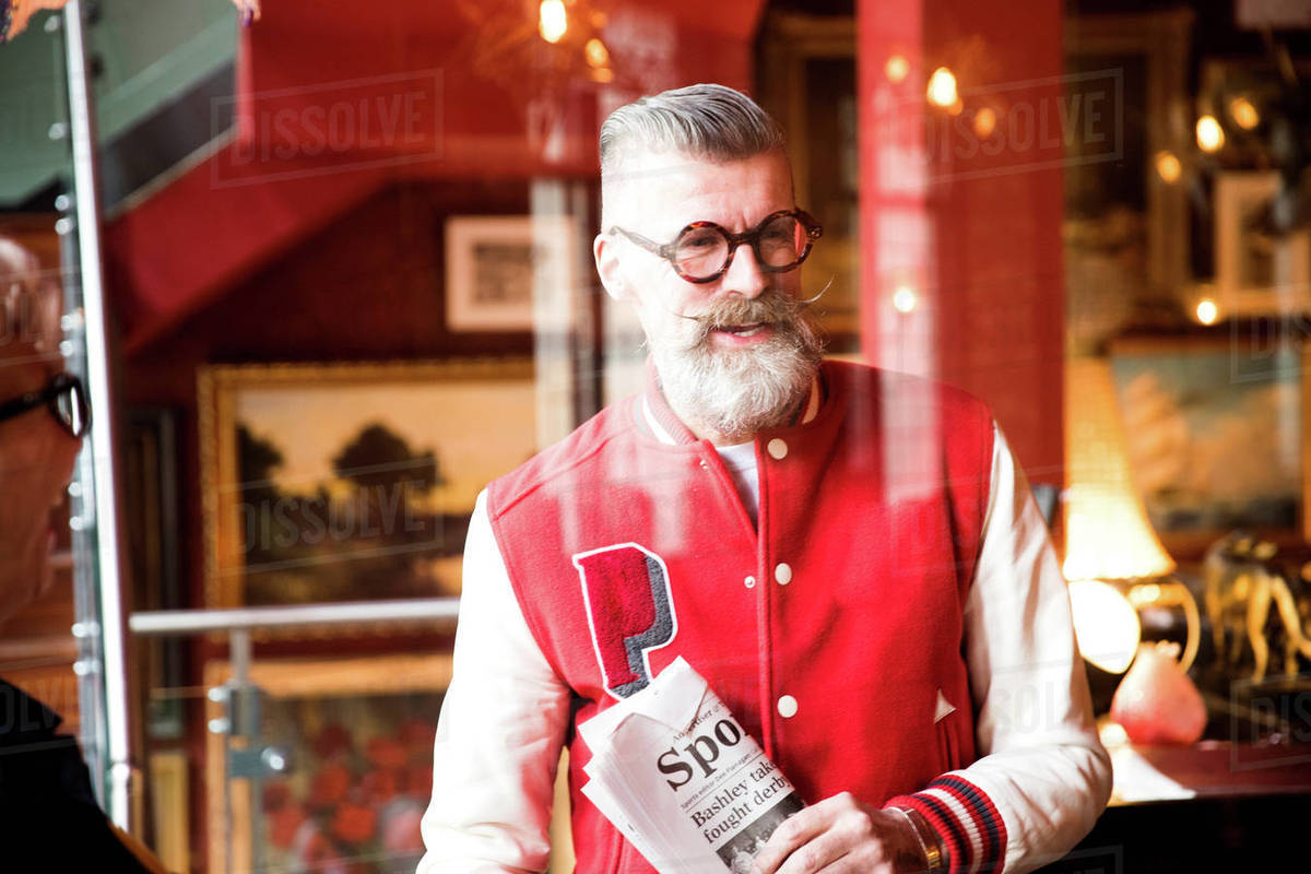 Quirky man with sports newspapers in bar and restaurant, Bournemouth ...