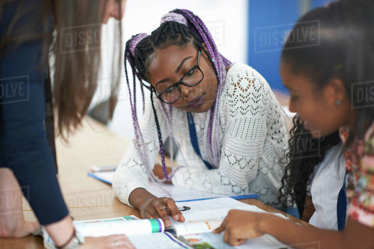 Teacher in classroom helping students study - Royalty-free Stock Photo ...