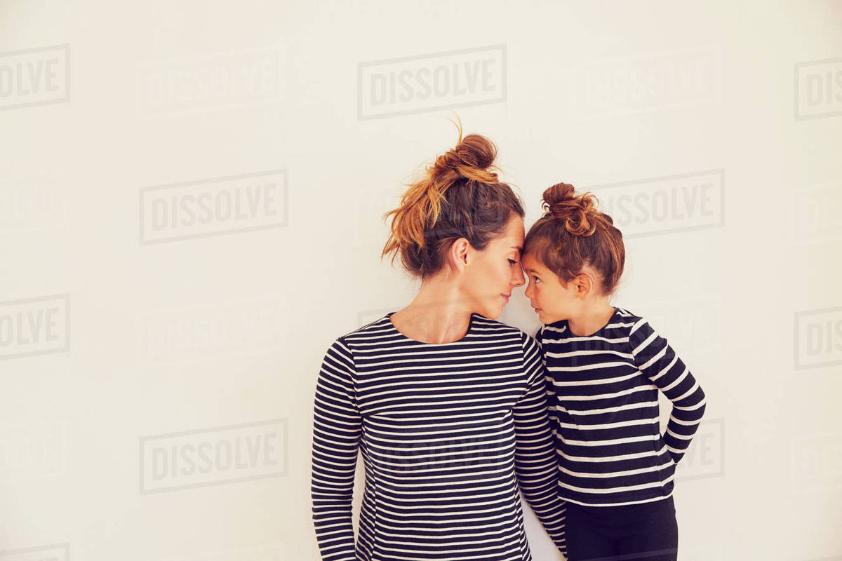 Portrait of mother and daughter, face to face - Stock Photo - Dissolve