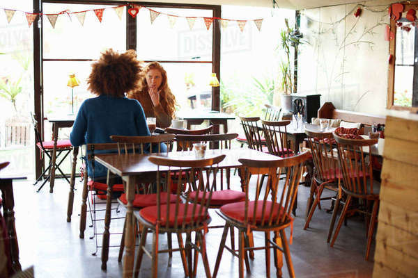 Friends relaxing in cafe, chatting - Royalty-free Stock Photo | Dissolve
