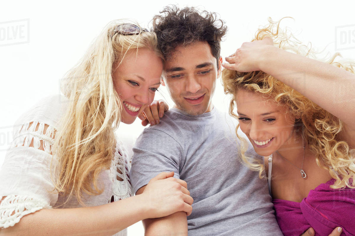 Friends huddled together smiling, looking down - Royalty-free Stock ...