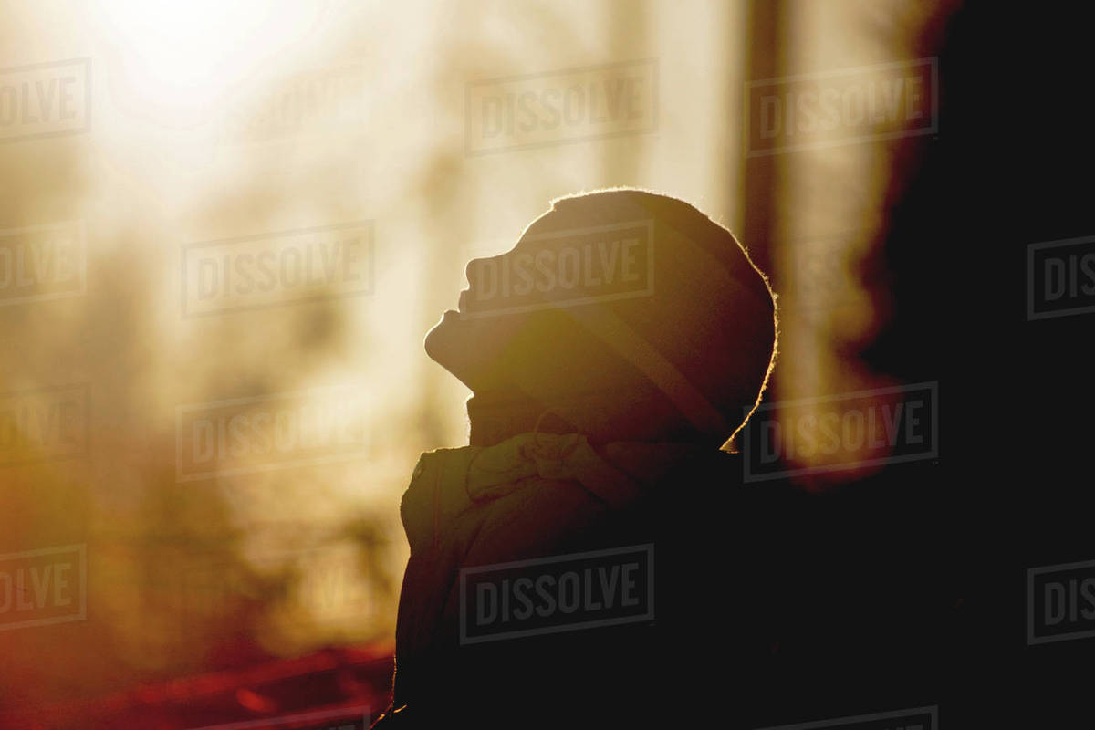 Silhouette of child looking up - Stock Photo - Dissolve