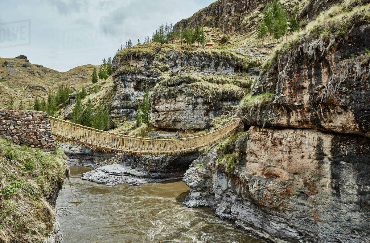 Inca rope bridge crossing river ravine, Huinchiri, Cusco, Peru ...