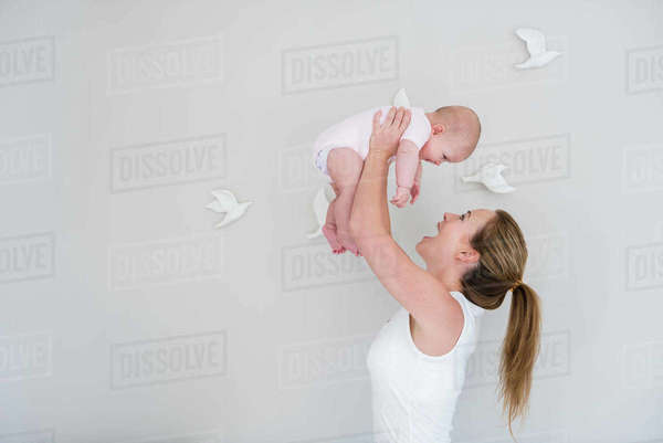 Mother lifting baby up - Royalty-free Stock Photo | Dissolve