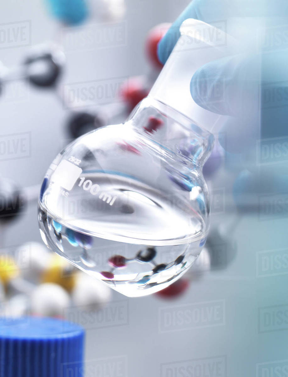 Scientist preparing chemical formula in a laboratory flask during an ...
