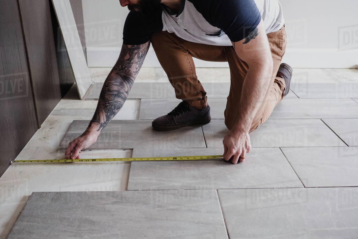 Cropped view of man measuring floor tiles - Royalty-free Stock Photo ...
